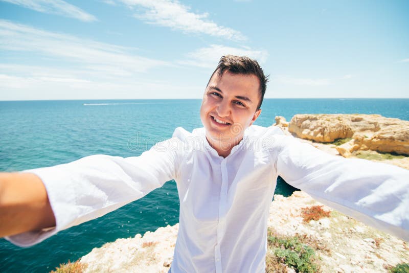 Handsome Young Man Taking A Selfie From Camera On Vacation On Ocean And