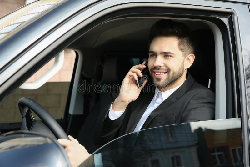 Handsome Young Man Talking on Smartphone while Driving Car Stock Photo ...