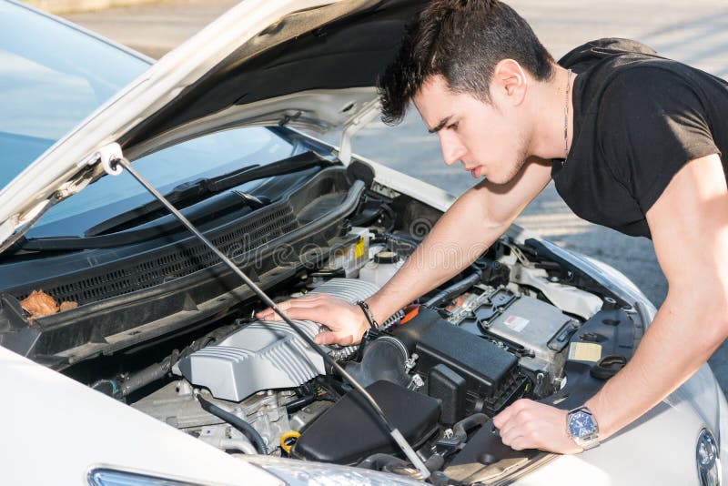 Handsome Young Man Trying To Repair a Car Engine Stock Image - Image of ...