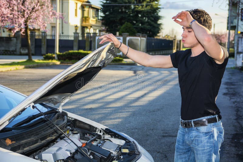 Handsome Young Man Trying To Repair a Car Engine Stock Photo - Image of ...