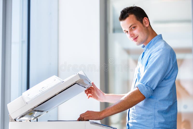 Handsome Young Man Using a Copy Machine Stock Image - Image of ...