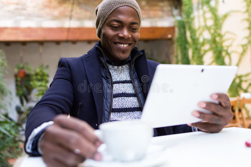 Handsome Young Man Using His Digital Tablet In The Cafe Stock Image