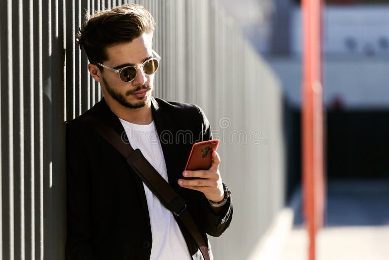 Handsome Young Man Using His Mobile Phone in the Street. Stock Image ...