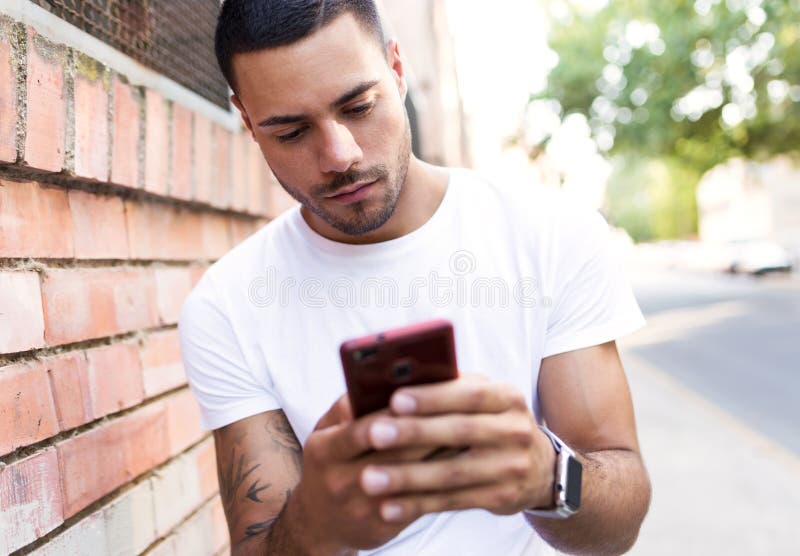Handsome Young Man Using His Mobile Phone in the Street. Stock Image ...