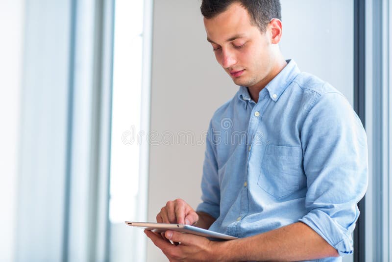 Handsome Young Man Using His Tablet Computer Stock Image - Image of ...