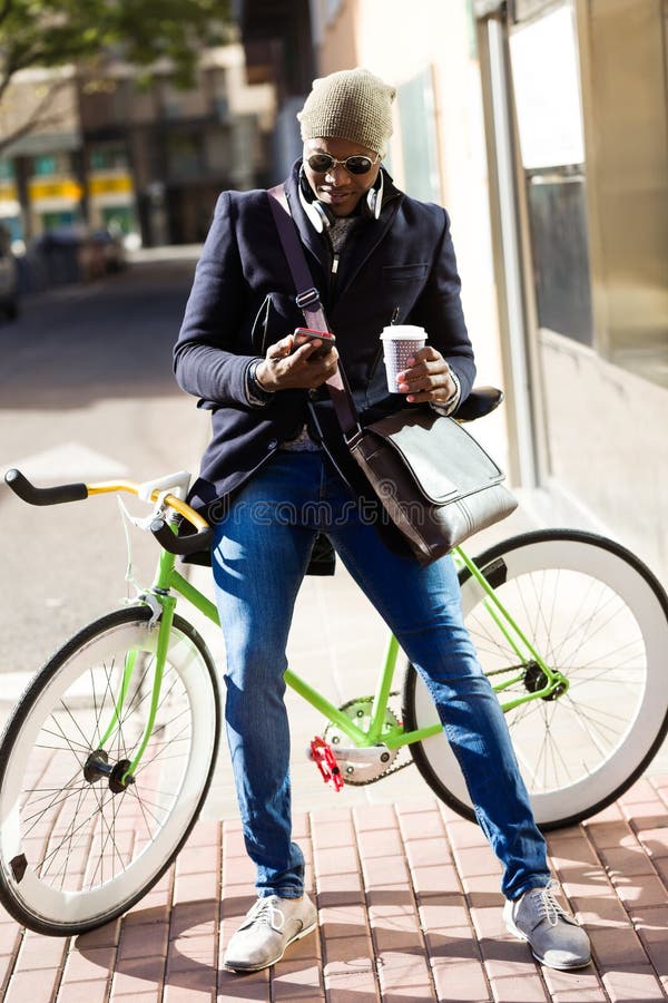 Handsome Young Man Using Mobile Phone and Fixed Gear Bicycle in the ...