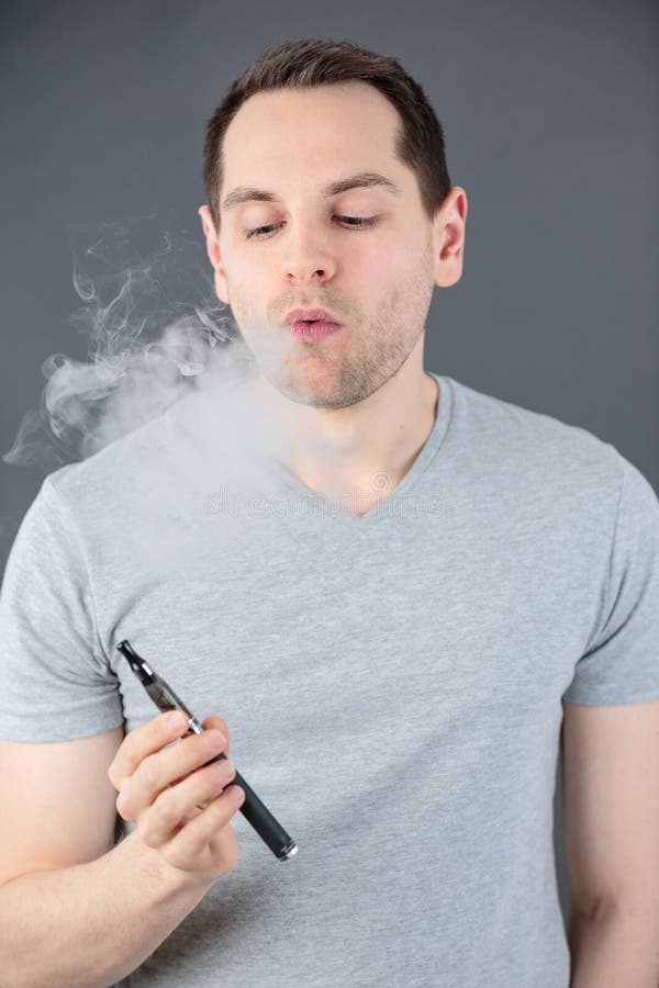 Handsome young man vaping stock photo. Image of ecig - 127174580