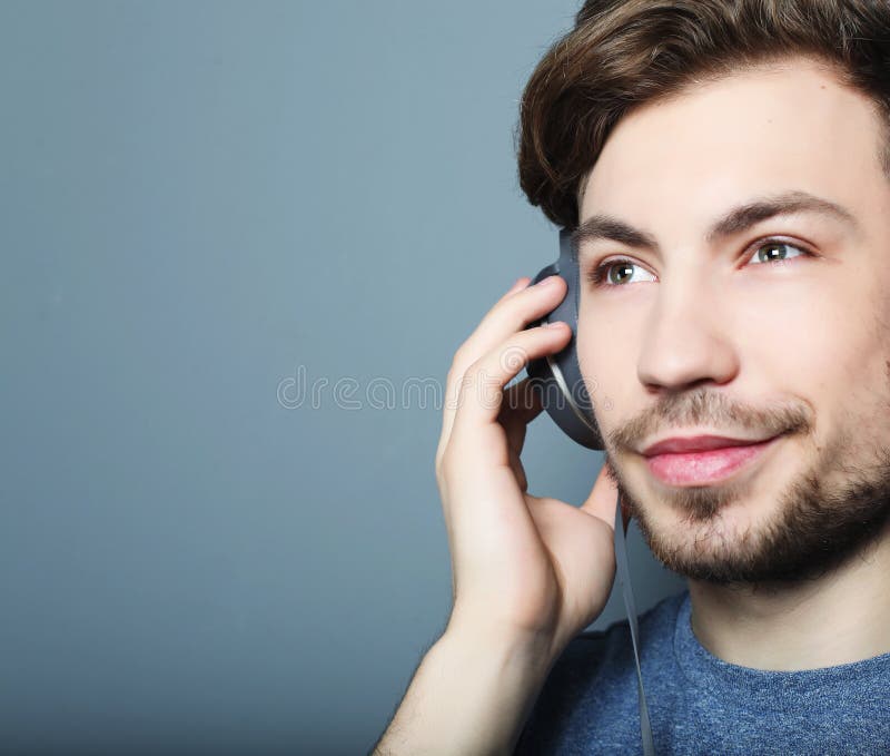Handsome Young Man Wearing Headphones And Listening To Music Stock