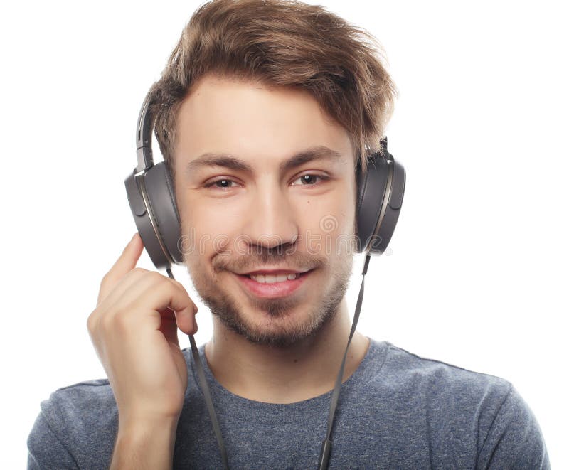 Handsome Young Man Wearing Headphones And Listening To Music Stock