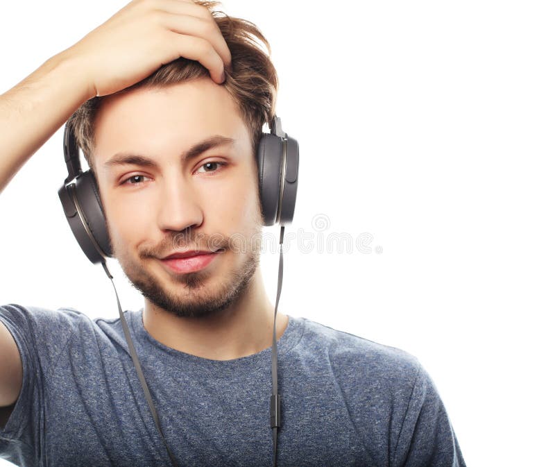 Handsome Young Man Wearing Headphones And Listening To Music Stock