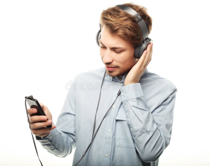 Handsome Young Man Wearing Headphones And Listening To Music Stock