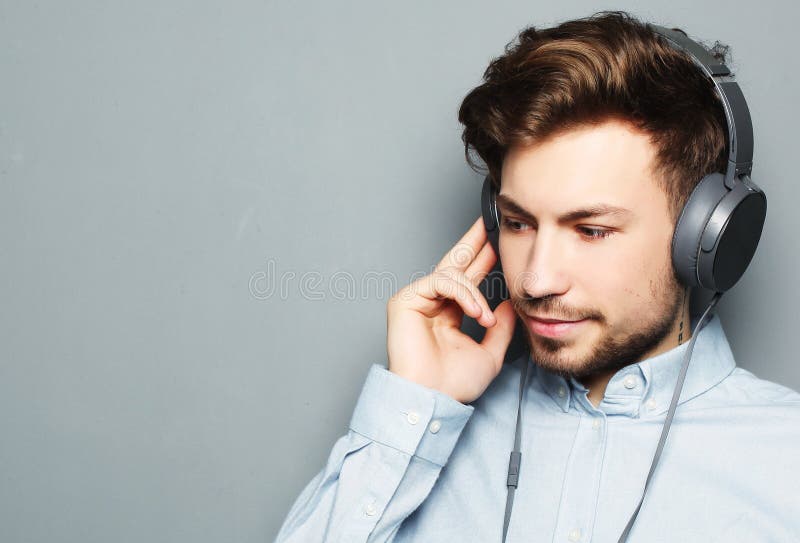 Handsome Young Man Wearing Headphones And Listening To Music Stock