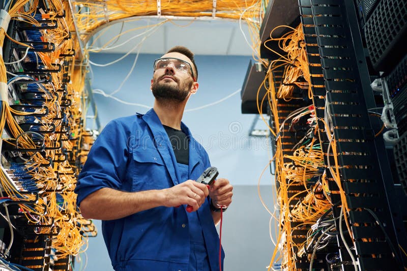 Handsome Young Man is Working with Internet Equipment and Wires in ...