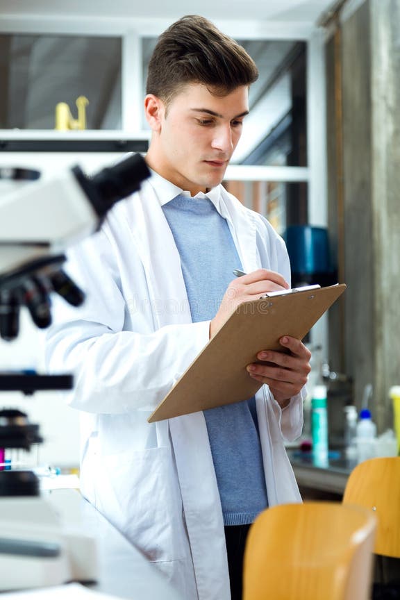 Handsome Young Man Working in Laboratory. Stock Photo - Image of notin ...