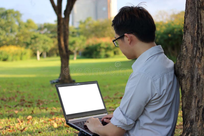 Handsome Young Man is Working with Laptop Computer for His Work in City ...
