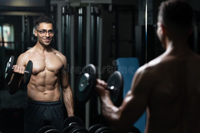 Handsome Young Man Working Out Biceps in Gym Stock Photo - Image of ...