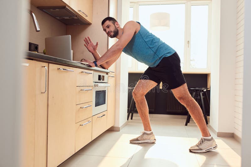 Handsome Young Man Working Out in Kitchen at Home Stock Photo - Image ...