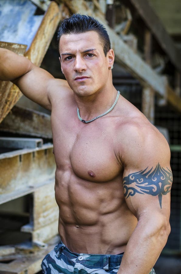 Handsome Young Muscle Man with Hand on Rusty Metal Structure Stock ...