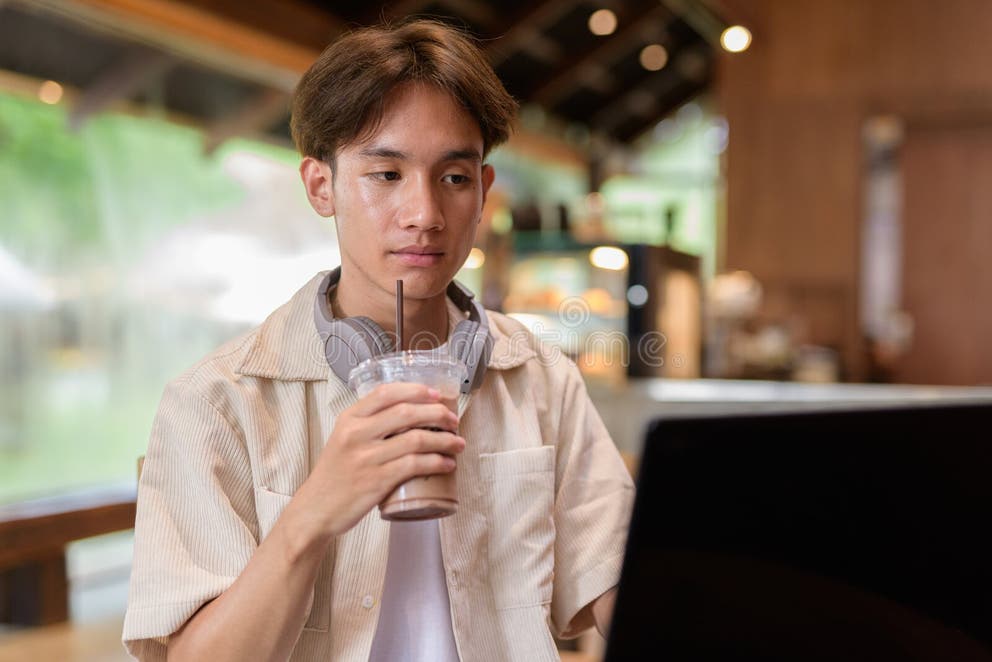 Handsome Young Non Binary Man Sitting in Cafe Restaurant Using Laptop Computer Stock Image ...