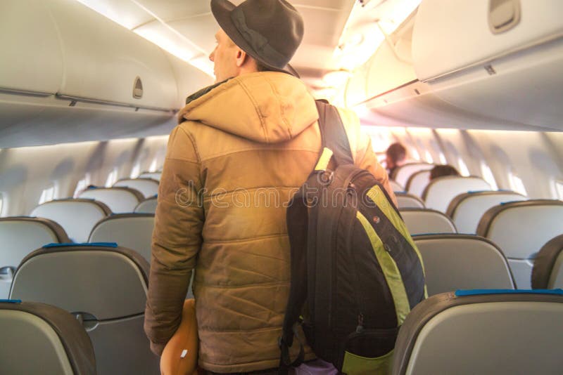 Handsome Young Passenger in a Warm Jacket and Hat Stands with a ...
