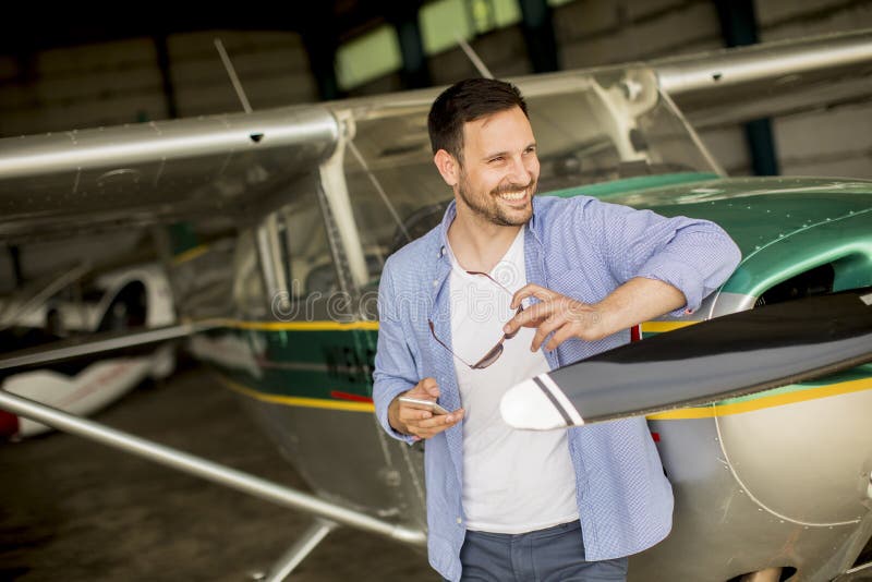 Young Pilot Checking Airplane in the Hangar Stock Image - Image of ...