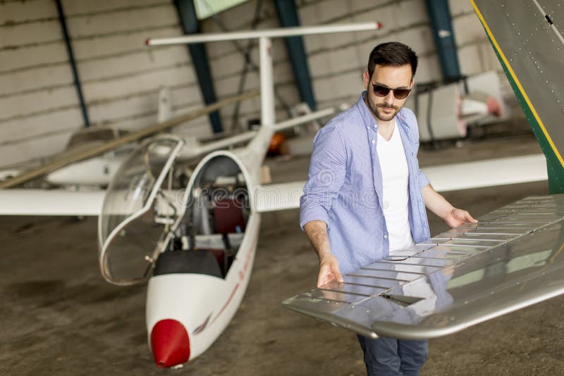 Young Pilot Checking Airplane in the Hangar Stock Image - Image of ...