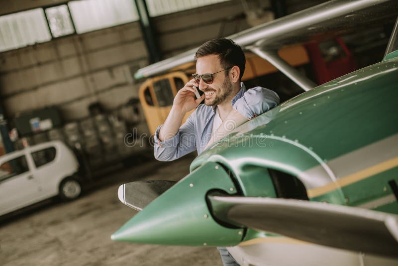 Young Pilot Checking Airplane in the Hangar Stock Image - Image of ...