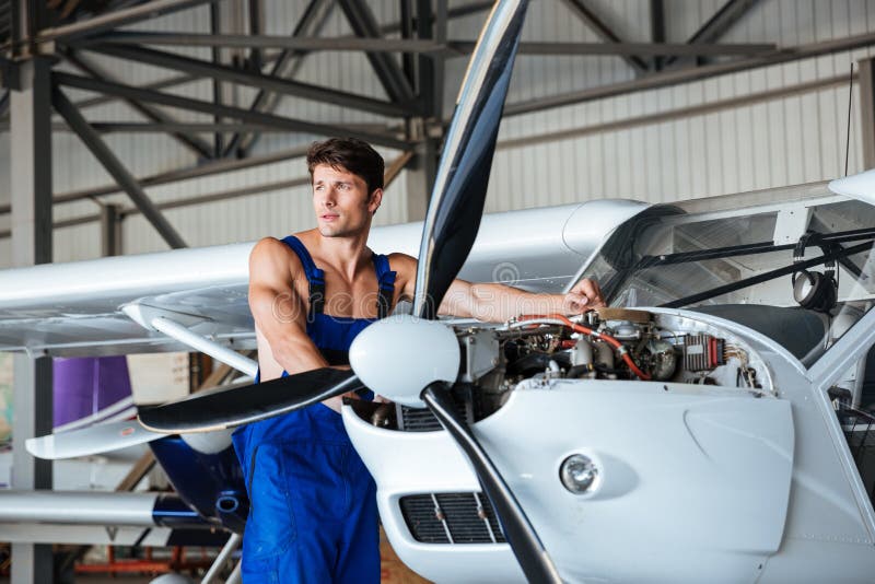 Handsome Young Repair Man Fixing Plane Engine Stock Photo - Image of ...