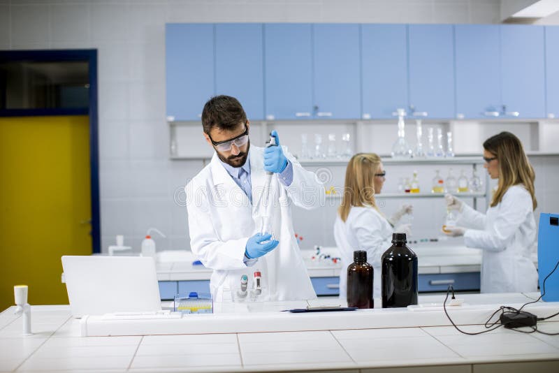 Young Researcher in Protective Workwear Standing in the Laboratory and ...
