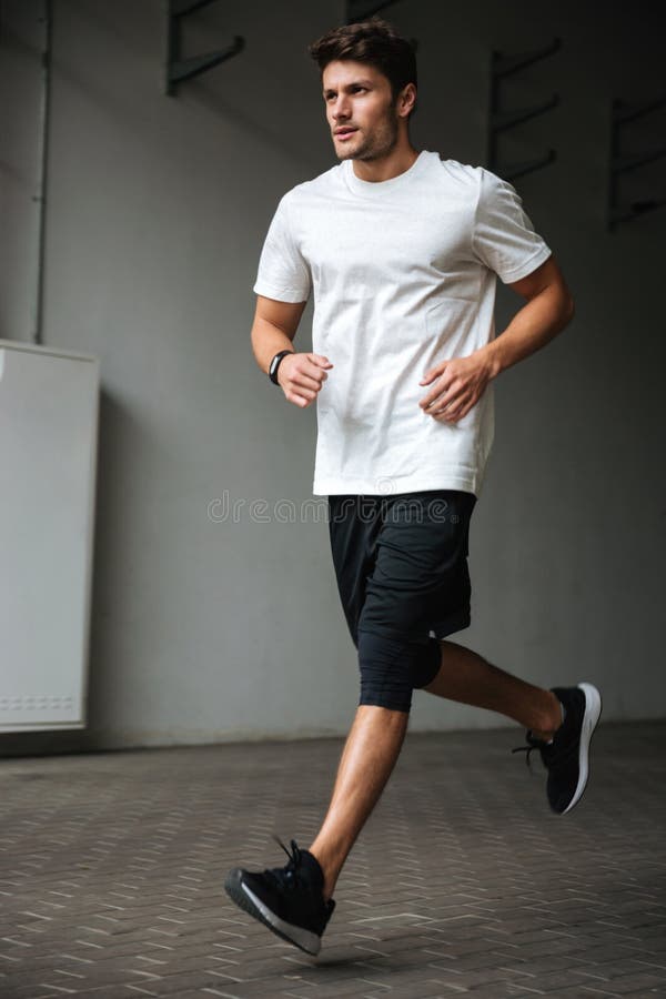 Handsome Young Sports Man Running at the Stadium Stock Image - Image of ...