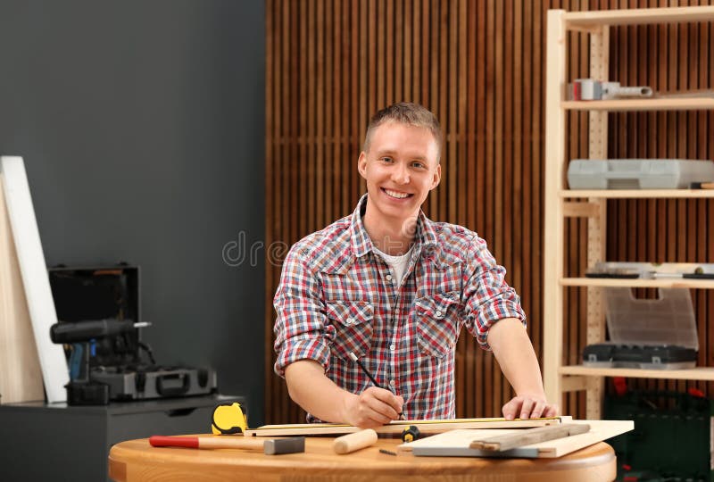 Handsome Young Working Man Making Marks on Timber at Table Indoors ...