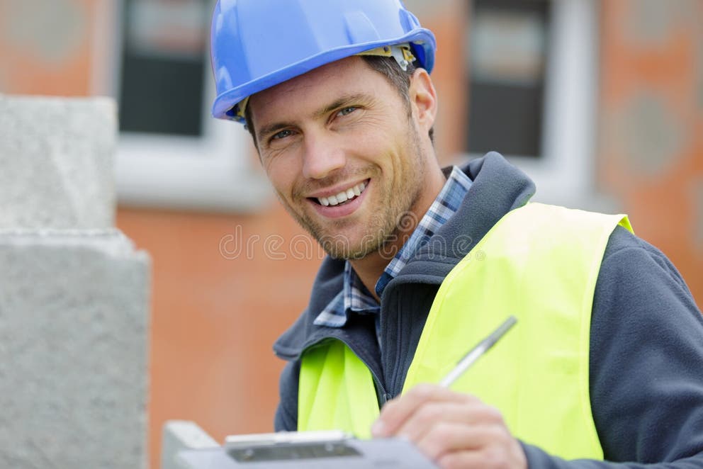 Handsomen Builder Writing on Clipboard Stock Image - Image of intern ...