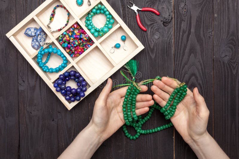 Handwork at Home, the Girl Makes Jewelry Hands on the Table Stock Image ...
