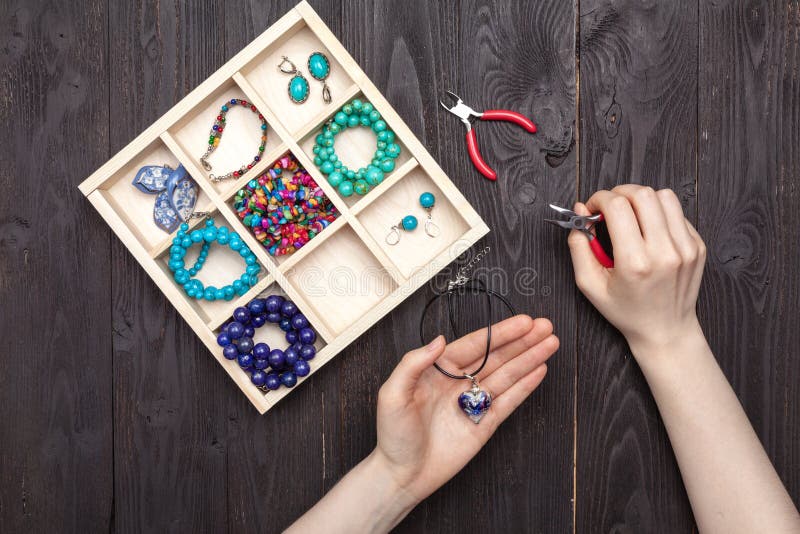 Handwork at Home, the Girl Makes Jewelry Hands on the Table Stock Photo ...