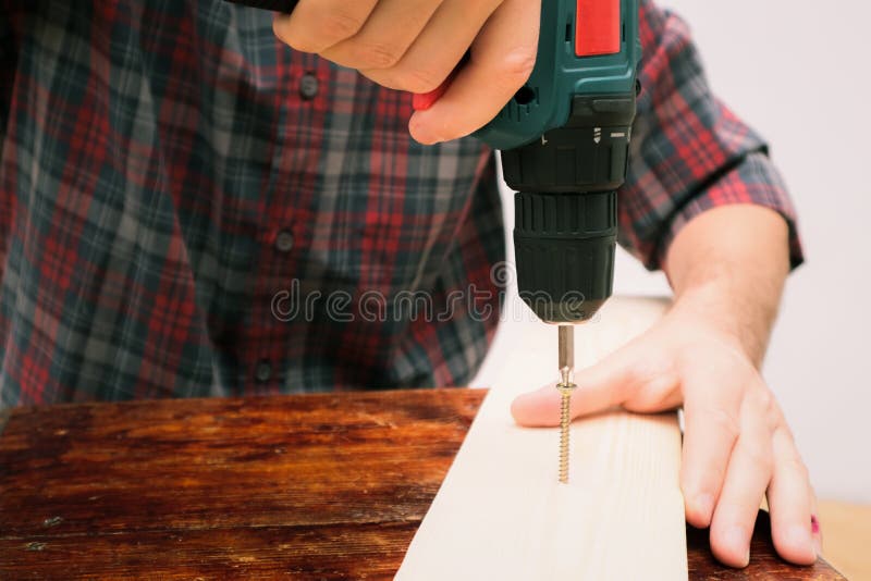 Handworker Working with an Electric Screwdriver. Carpenter Fixing ...