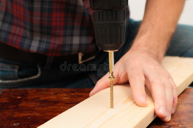 Handworker Working with an Electric Screwdriver. Carpenter Fixing ...