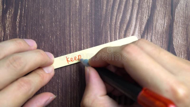 Handwriting "Keep Going" in Red Marker on a Wooden Tag Stock Video ...