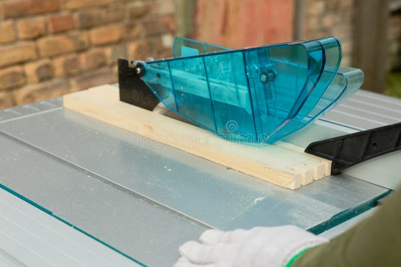 Handy Man Cutting Wood on a Table Saw. Carpentry Wood Work Stock Photo ...