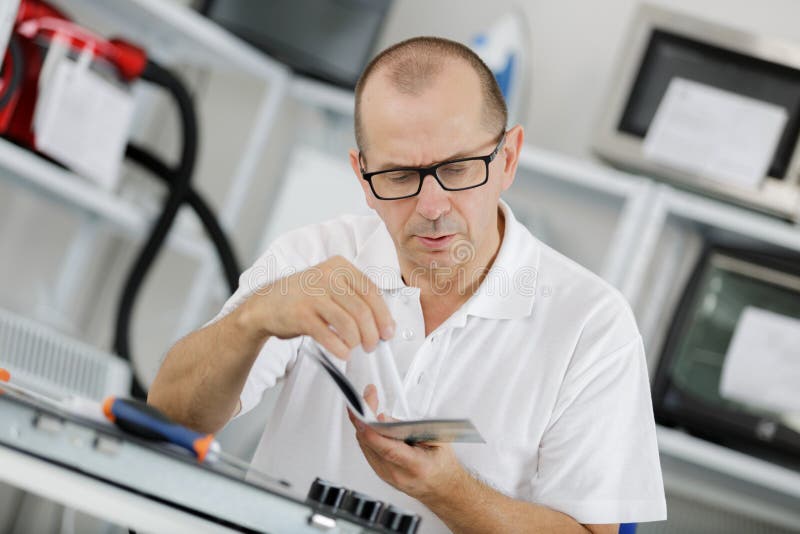 Handy Man Reading Instruction Manual Stock Image - Image of serviceman ...