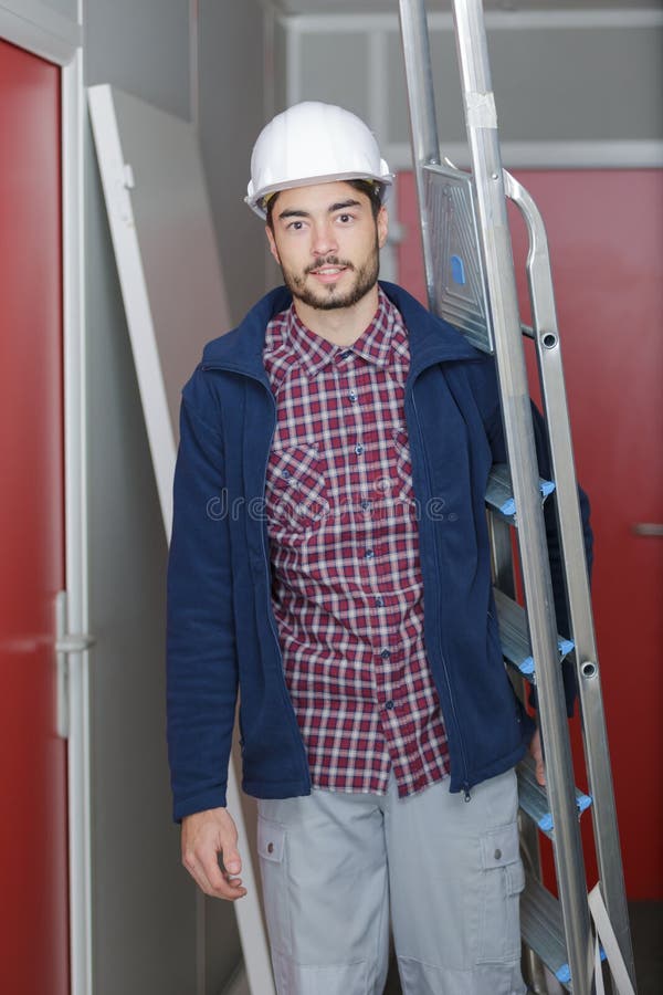 Handyman carrying ladder stock image. Image of renovation - 261951545