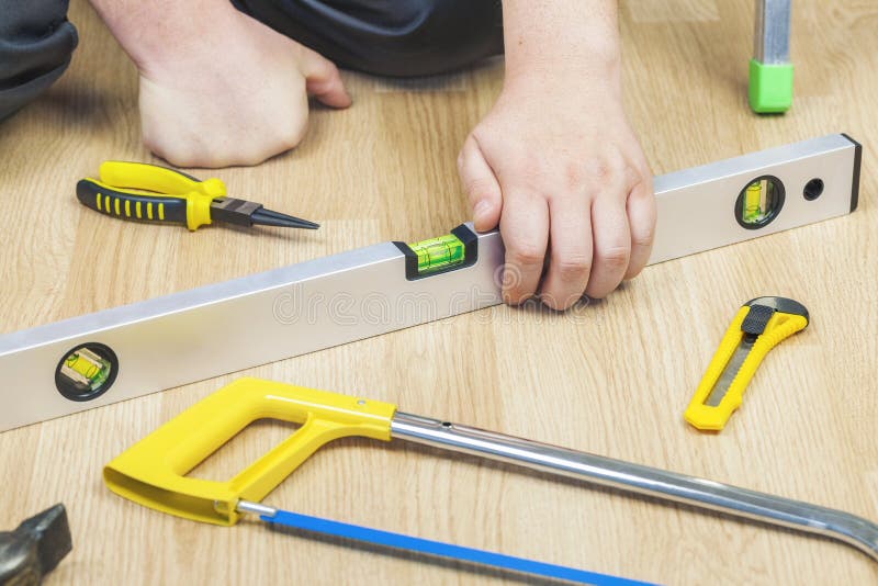 Handyman check floor level stock photo. Image of level - 172602910