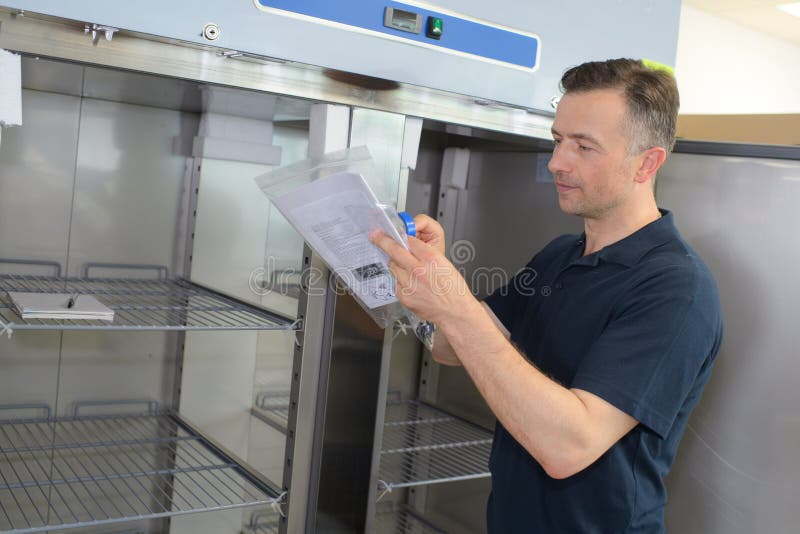 Handyman Checking Refrigerator at Home Stock Image - Image of fixing ...