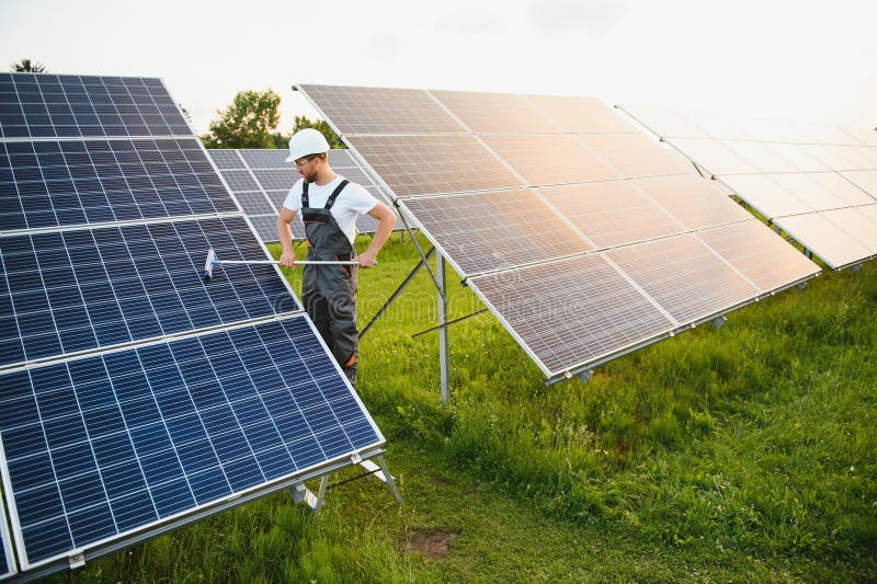 A Handyman Cleaning Solar Panels Form Dust and Dirt. Stock Image ...