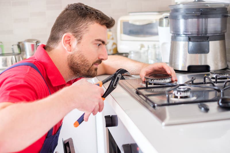 Handyman Fixing Gas Stove in the Kitchen Stock Image - Image of ...