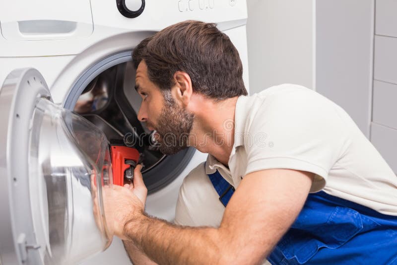 Handyman Fixing a Washing Machine Stock Photo - Image of serviceman ...