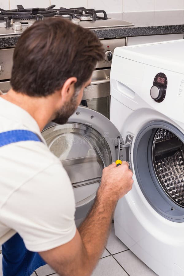 Handyman Fixing a Washing Machine Stock Image - Image of adult ...