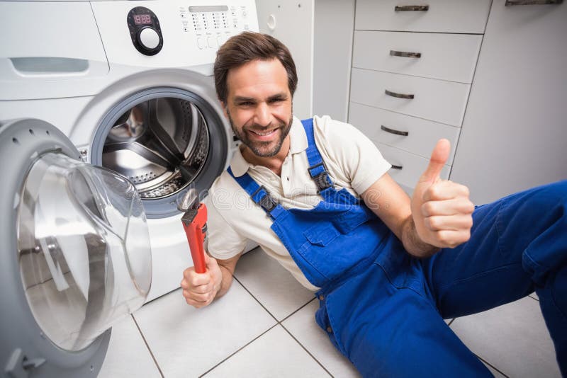 Handyman Fixing a Washing Machine Stock Photo - Image of wrench, worker ...