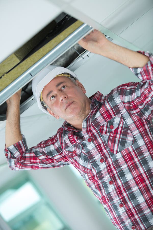 Handyman Hiding Cable in Ceiling Stock Image - Image of cable, skirting ...