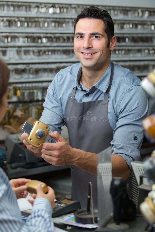 Handyman Holding Lock while Looking at Camera in Workshop Stock Photo ...