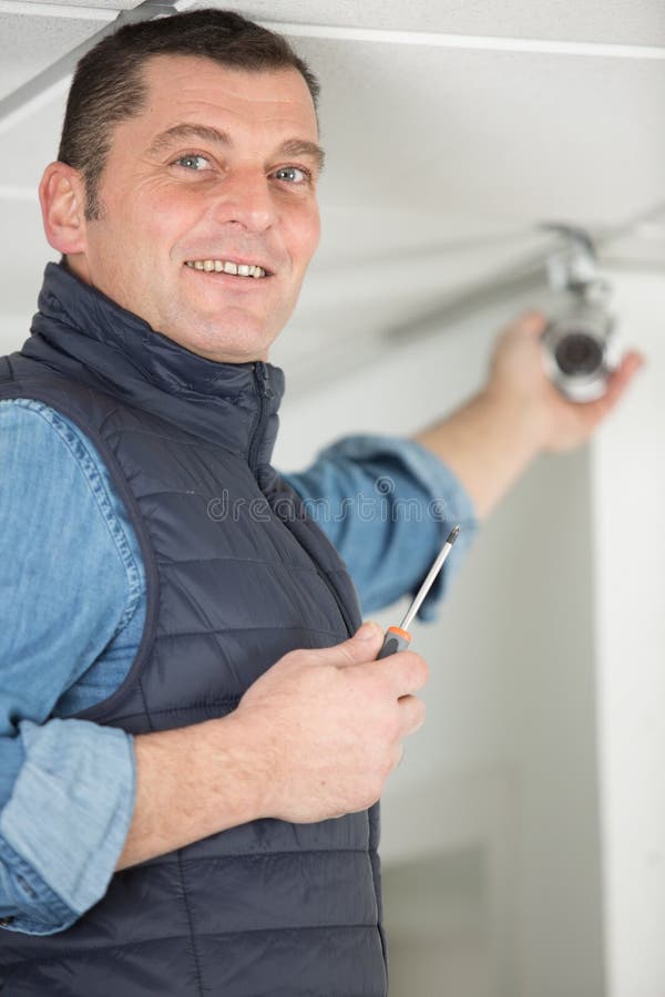 Handyman Installing Security Camera on Ceiling Stock Photo - Image of ...